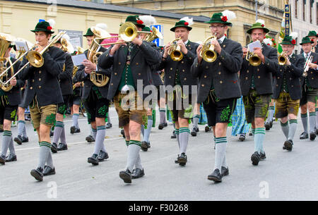 A wind instrument parade - people in costumes walking on the street ...