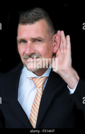 Portrait of a man trying to listen Stock Photo - Alamy