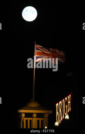 The full moon rises above a solar panel in the early morning in Phnom ...
