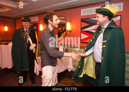 Traditional Sabrage evening, with people slicing open a bottle of ...