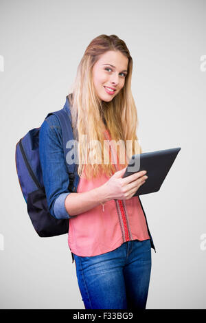 Composite image of student using tablet in library Stock Photo - Alamy