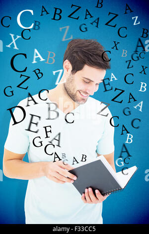 Young man reading a book with alphabet letters Stock Photo - Alamy