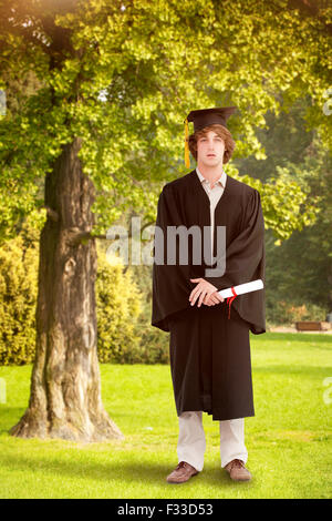 Male student in graduate robe jumping Stock Photo - Alamy