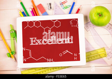 Excellent! against students desk with tablet pc Stock Photo - Alamy