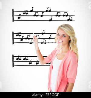 Pretty, young college student writing on the chalkboard/blackboard ...