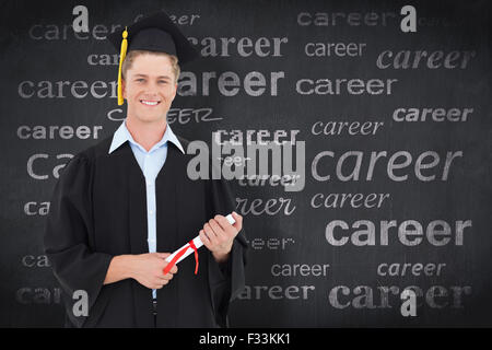 Young handsome graduated man holding degree over isolated background ...
