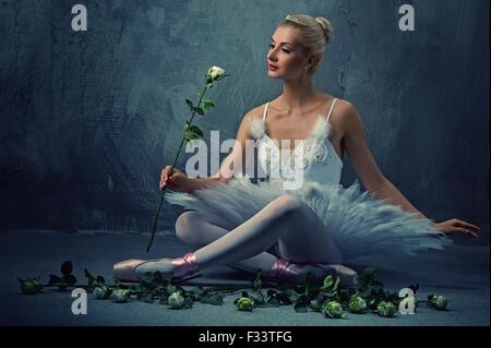 Beautiful ballet dancer with a white roses Stock Photo - Alamy