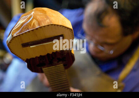 Artisan Adrian Villanueva Quisbert making a charango, a traditional ...