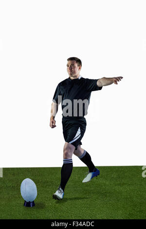 Rugby player doing a drop kick Stock Photo - Alamy