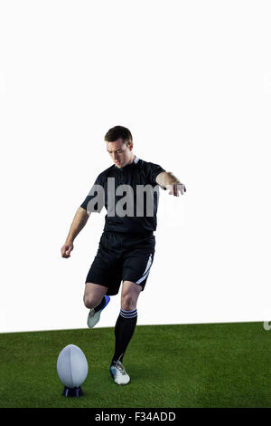 Rugby player doing a drop kick Stock Photo - Alamy