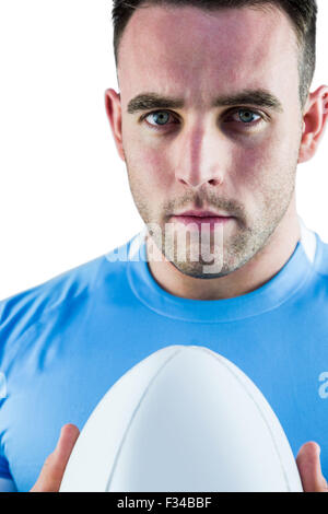 Rugby player looking at camera with ball Stock Photo - Alamy