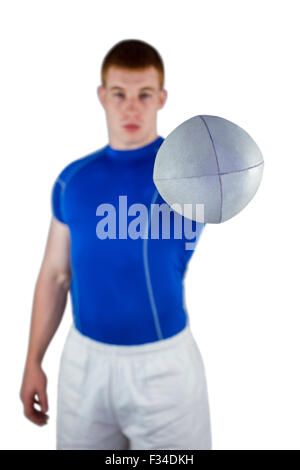 Rugby player handing a rugby ball Stock Photo - Alamy