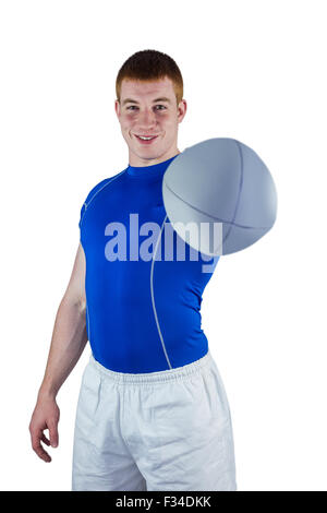 Rugby player handing a rugby ball Stock Photo - Alamy