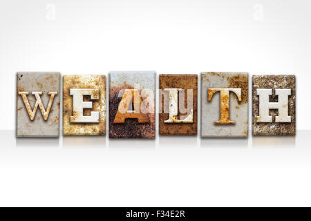 The word "WEALTH" written in rusty metal letterpress type on a crumbled ...
