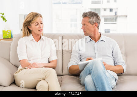 Concerned therapist listening to female patient Stock Photo - Alamy