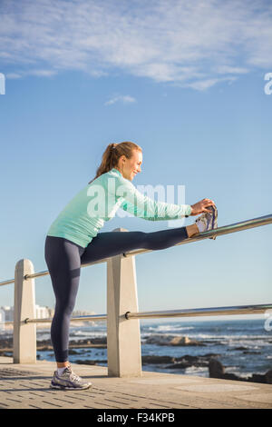 Fit blonde stretching her leg Stock Photo - Alamy