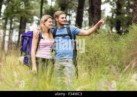 Young happy hiker couple pointing Stock Photo - Alamy