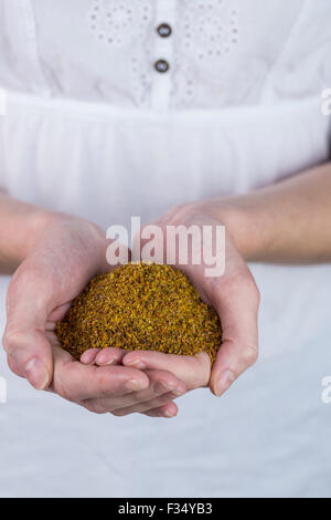 Woman showing handful of milled seed Stock Photo - Alamy