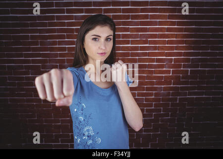 Pretty brunette punching to camera Stock Photo - Alamy