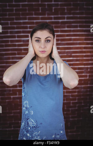Happy woman covering her ears with hands Stock Photo - Alamy