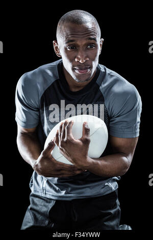 Rugby player smiling while catching ball Stock Photo - Alamy