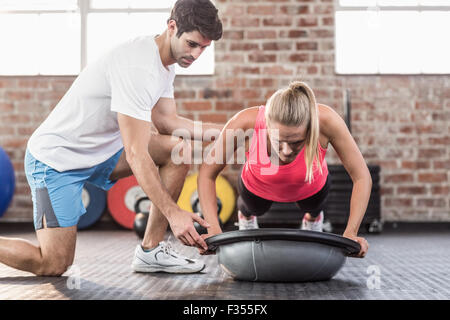 Trainer motivating client doing push ups Stock Photo - Alamy
