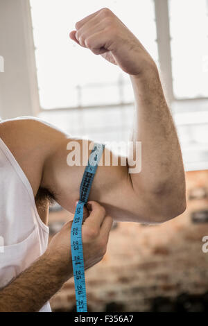 Man measuring his biceps Stock Photo - Alamy