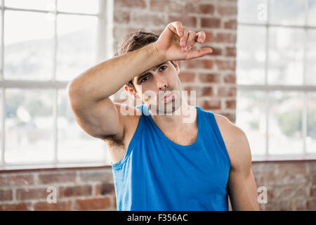 Man wiping his forehead with arm Stock Photo - Alamy