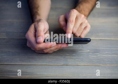 Man Using Mobile Phone At Desk In Busy Creative Office Stock Photo - Alamy