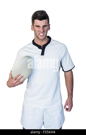 Portrait of an angry rugby player holding ball Stock Photo - Alamy