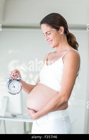 Alarm clock and the woman Stock Photo - Alamy
