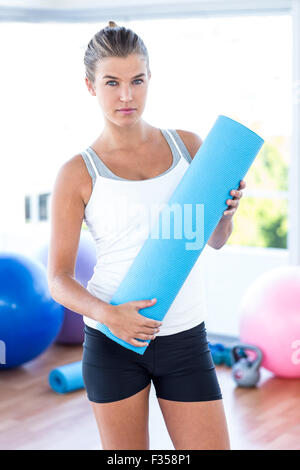 Beautiful woman with yoga mat on pink background Stock Photo - Alamy