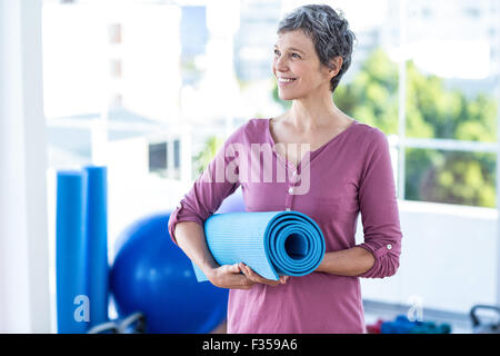 Thoughtful mature woman on pink background Stock Photo - Alamy