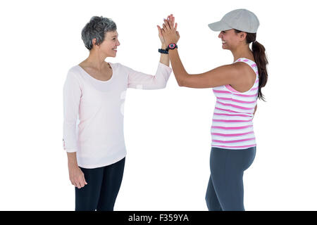 Cheerful women high fiving Stock Photo - Alamy