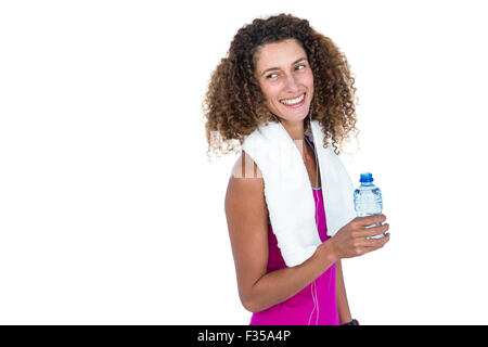 Young cheerful female with white towel on head holding small jar with ...