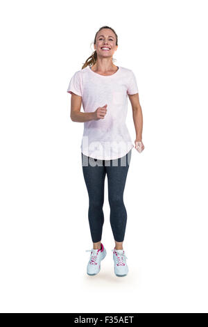 Young adult woman over white brick wall holding period calendar doing ...