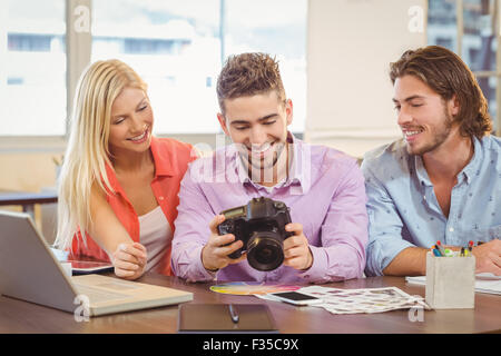 Happy business people looking at camera in a row Stock Photo - Alamy