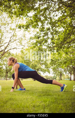 Young woman is doing stretching exercise on river bridge, preparing for ...