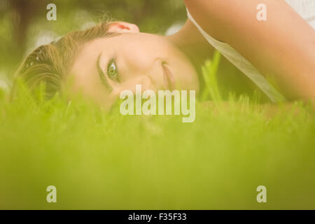 Side view of beautiful woman lying on grass Stock Photo - Alamy