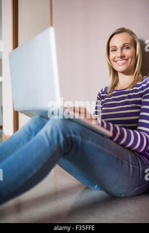 Portrait of a happy female student sitting at the desk in university ...
