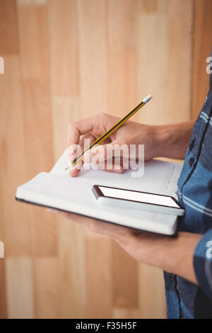 Cropped image of hand holding pencil while working in office Stock ...