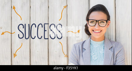Success against stylish brunette thinking and smiling Stock Photo - Alamy