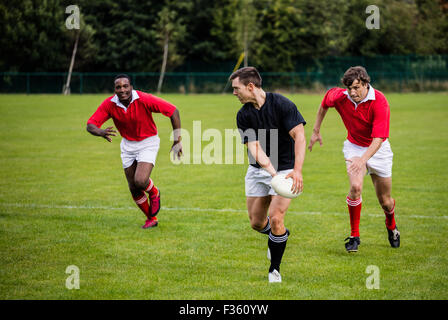 Rugby players running during game Stock Photo - Alamy