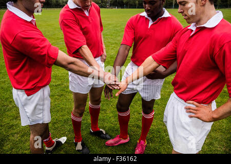 Rugby players putting hands together Stock Photo - Alamy