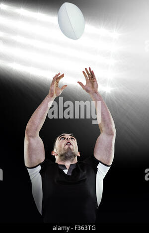 Composite image of rugby player catching a rugby ball Stock Photo - Alamy