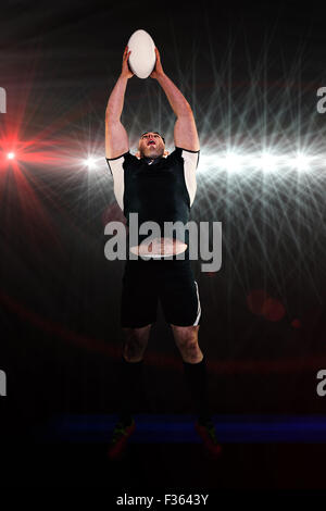Composite image of rugby player catching a rugby ball Stock Photo - Alamy