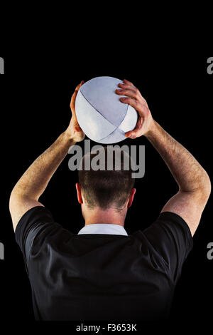 Composite image of rugby player about to throw a rugby ball Stock Photo ...