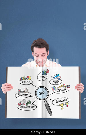 Composite image of man showing a book Stock Photo - Alamy