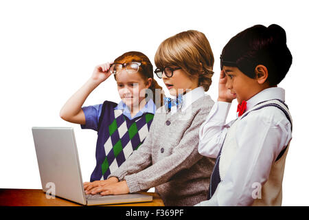 Composite image of pupils using laptop Stock Photo - Alamy