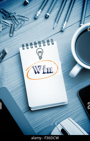 Win against notepad on desk Stock Photo - Alamy